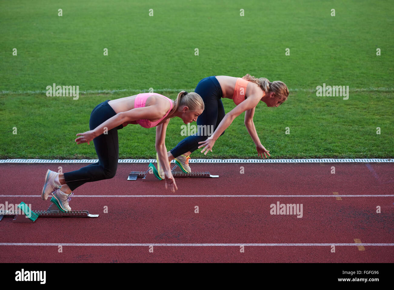 athlete woman group running on athletics race track Stock Photo - Alamy