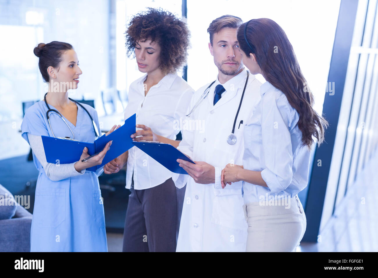 Doctors looking at medical report Stock Photo - Alamy