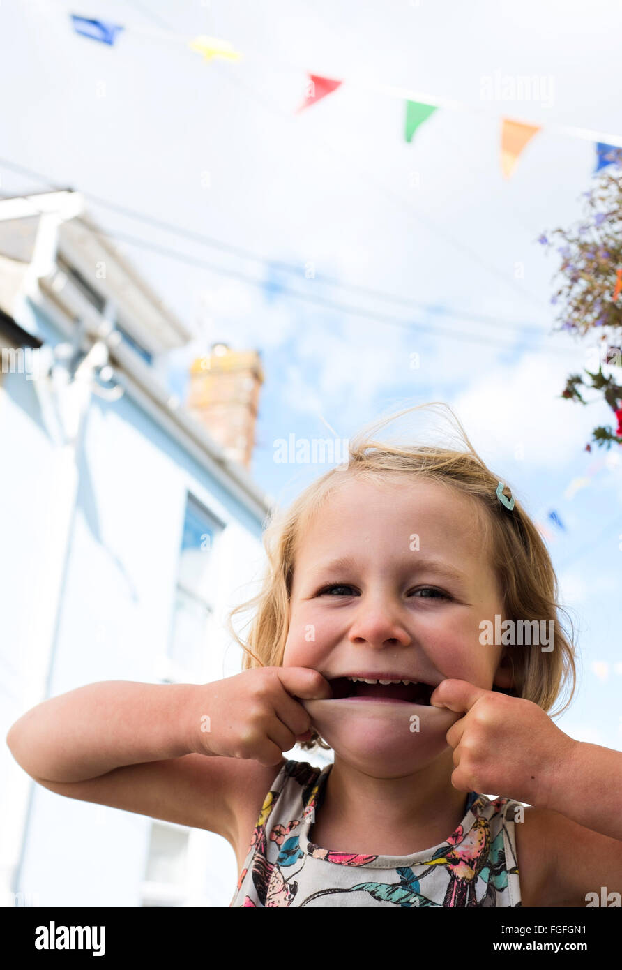 Girl pulling a cheeksface Stock Photo - Alamy