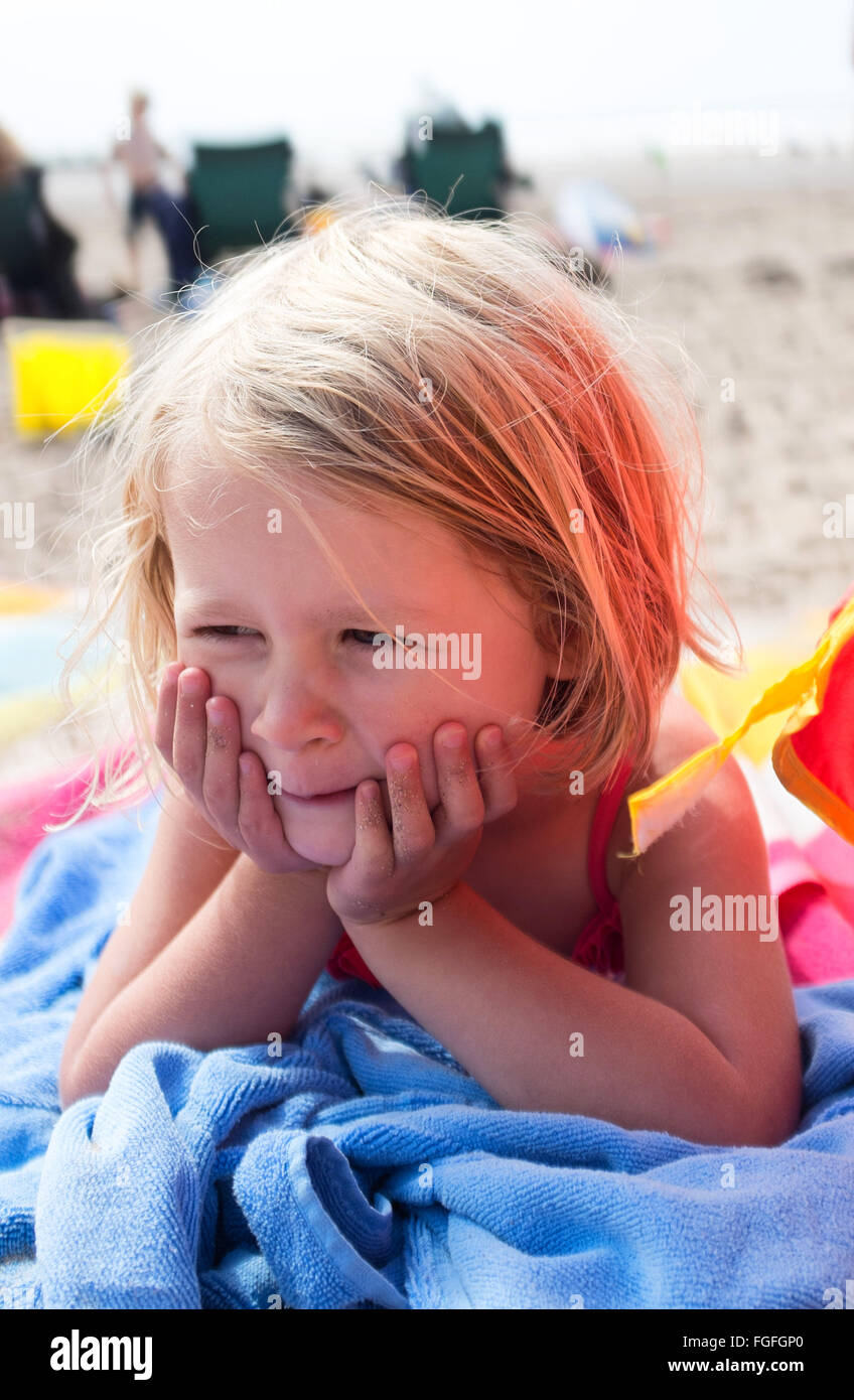 Slouching on beach Stock Photo - Alamy