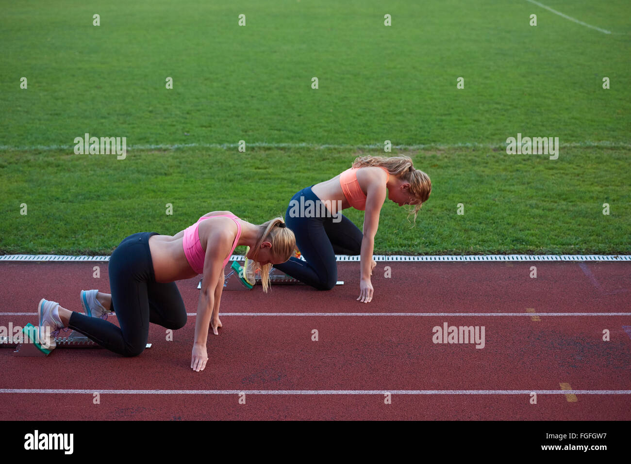 athlete woman group running on athletics race track Stock Photo - Alamy