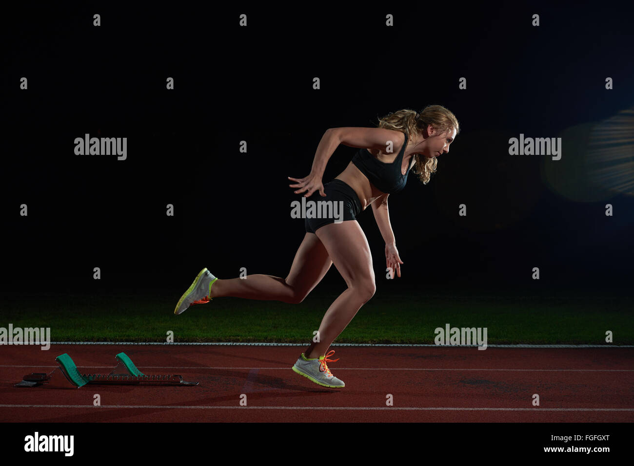 woman sprinter leaving starting blocks Stock Photo - Alamy