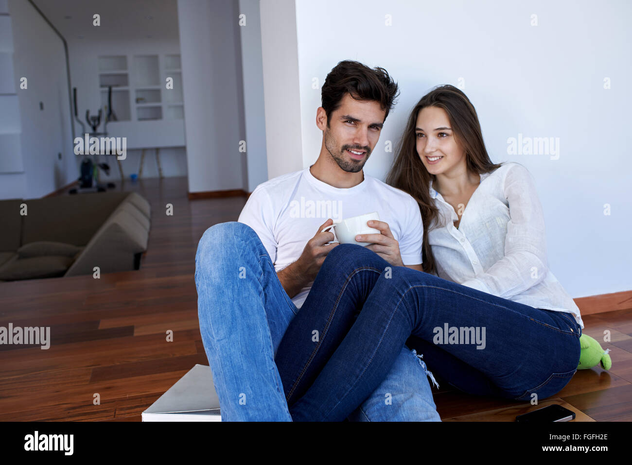 relaxed young couple at home staircase Stock Photo - Alamy