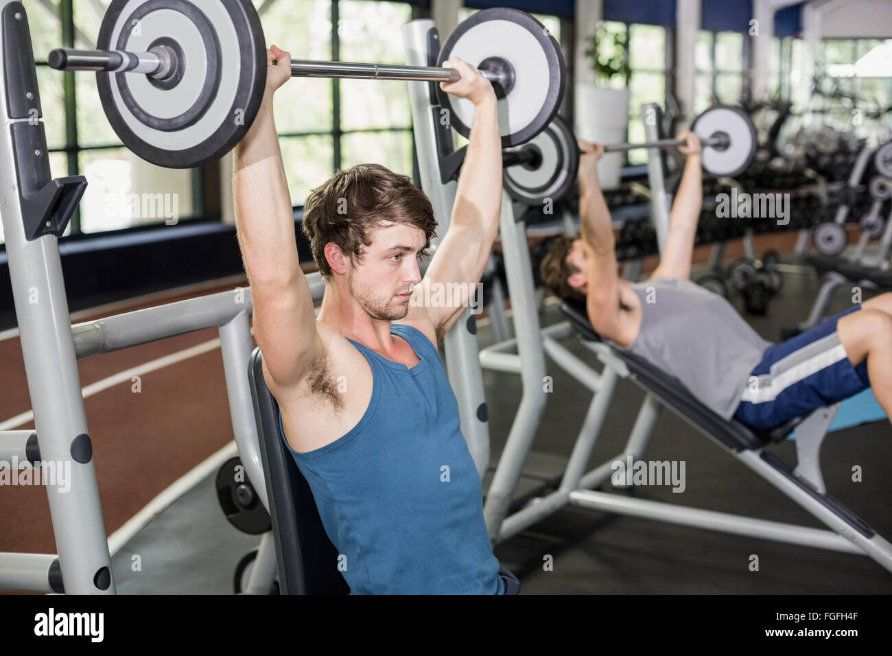 Fit man lifting barbell Stock Photo - Alamy