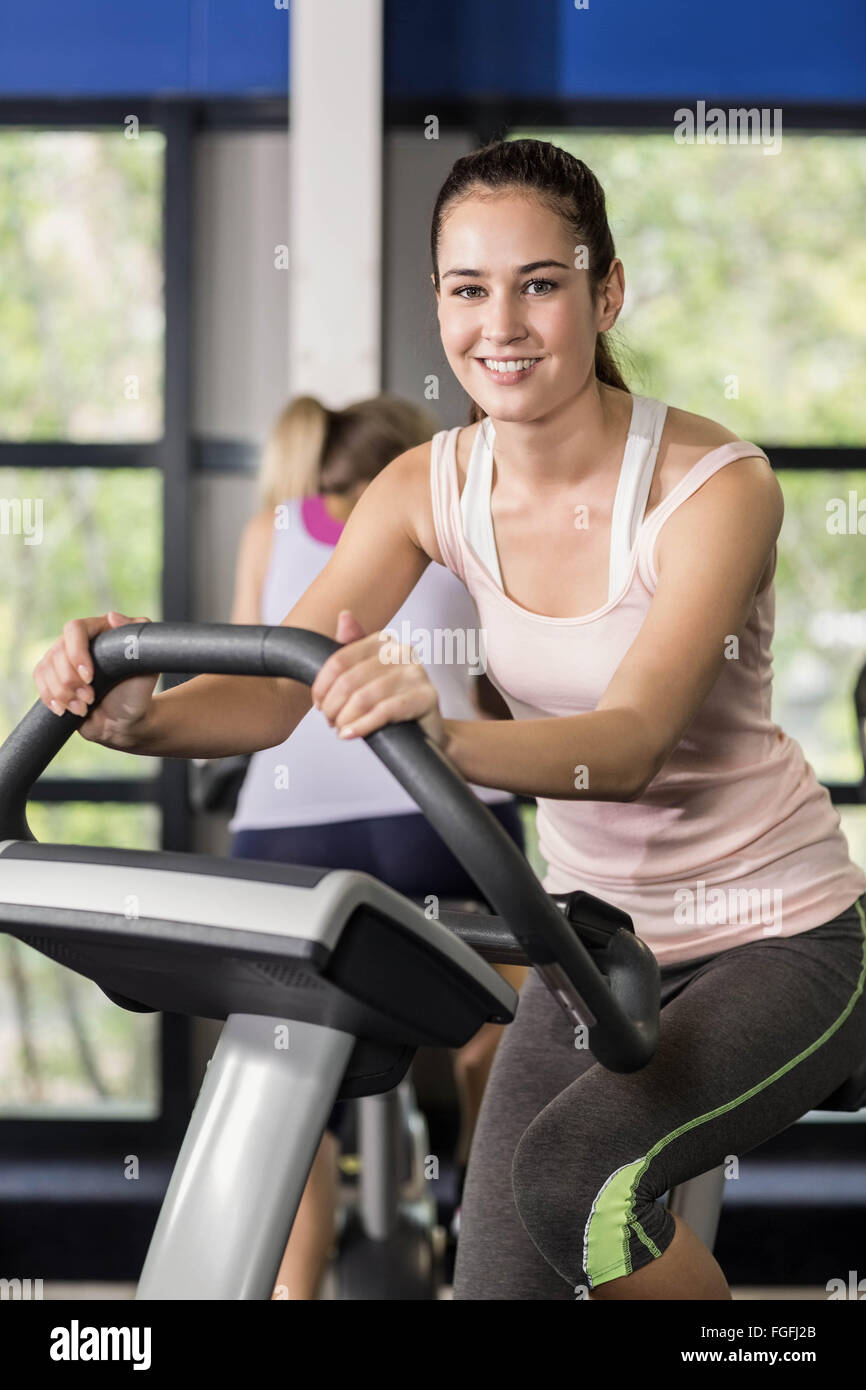 Fit woman doing exercise bike Stock Photo - Alamy