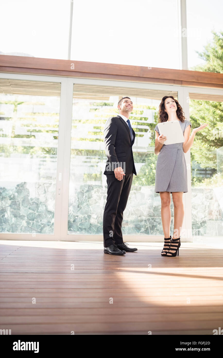 Real-estate agent showing young woman new home Stock Photo - Alamy
