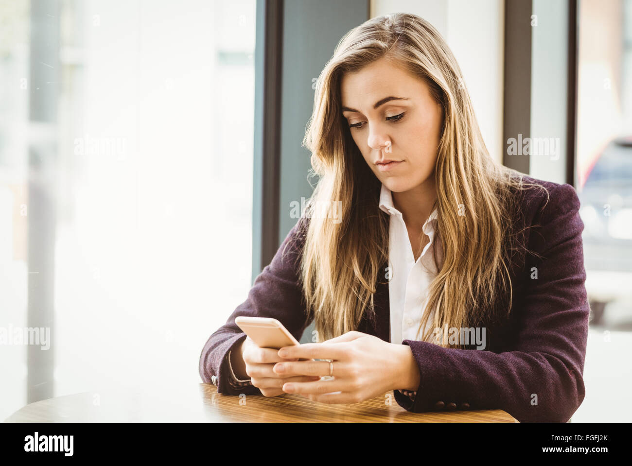 Cute blonde girl texting Stock Photo - Alamy