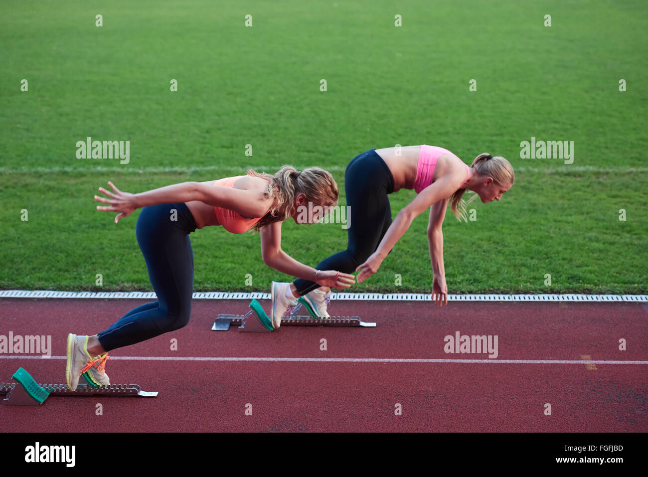 athlete woman group running on athletics race track Stock Photo - Alamy