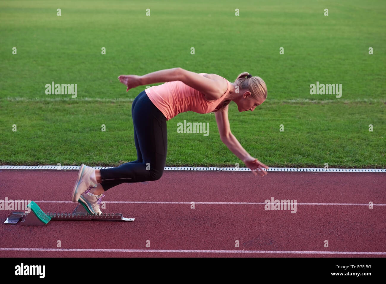 Female sprinter leaving starting blocks hi-res stock photography and ...