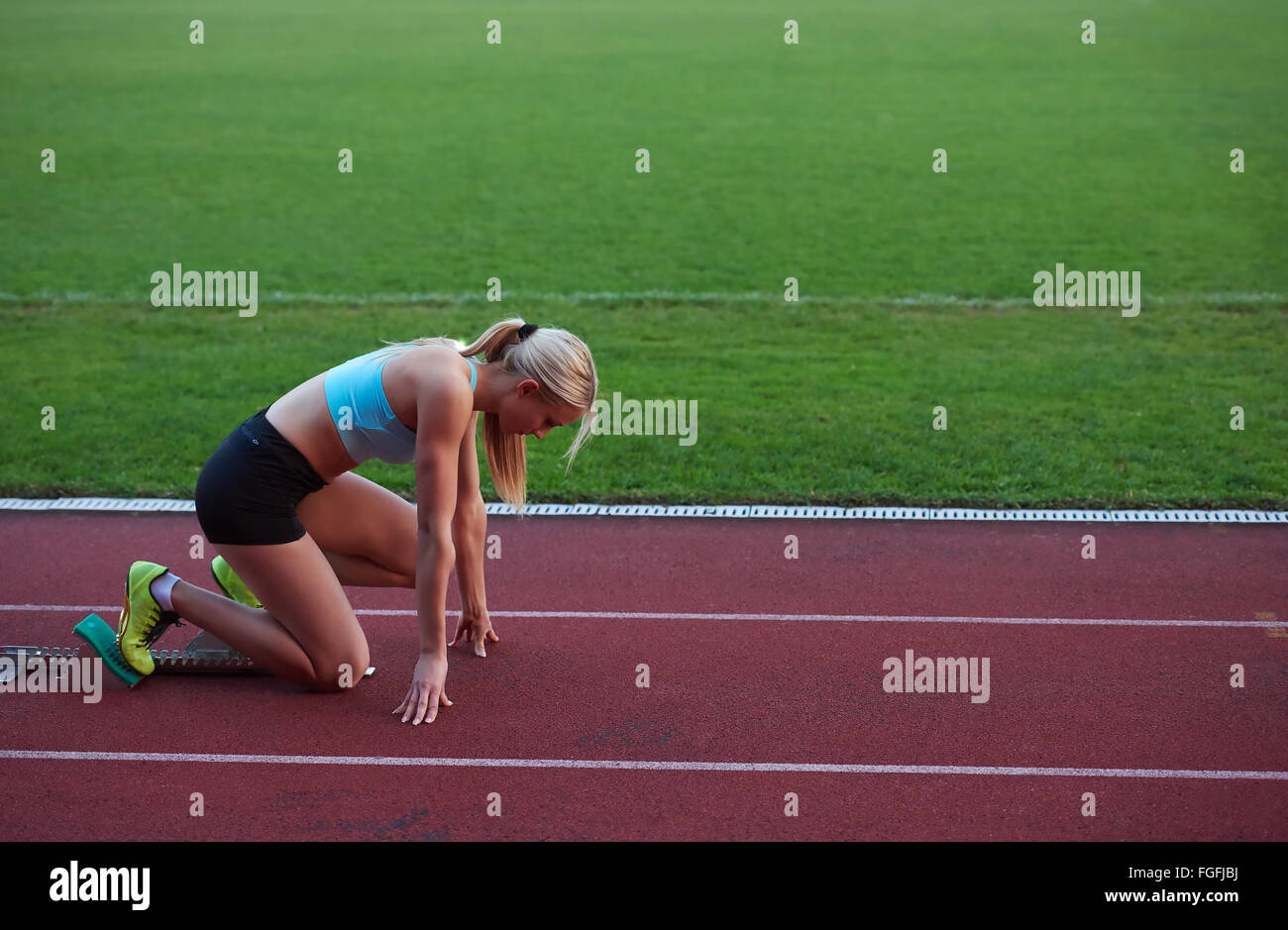 athlete woman group running on athletics race track Stock Photo - Alamy