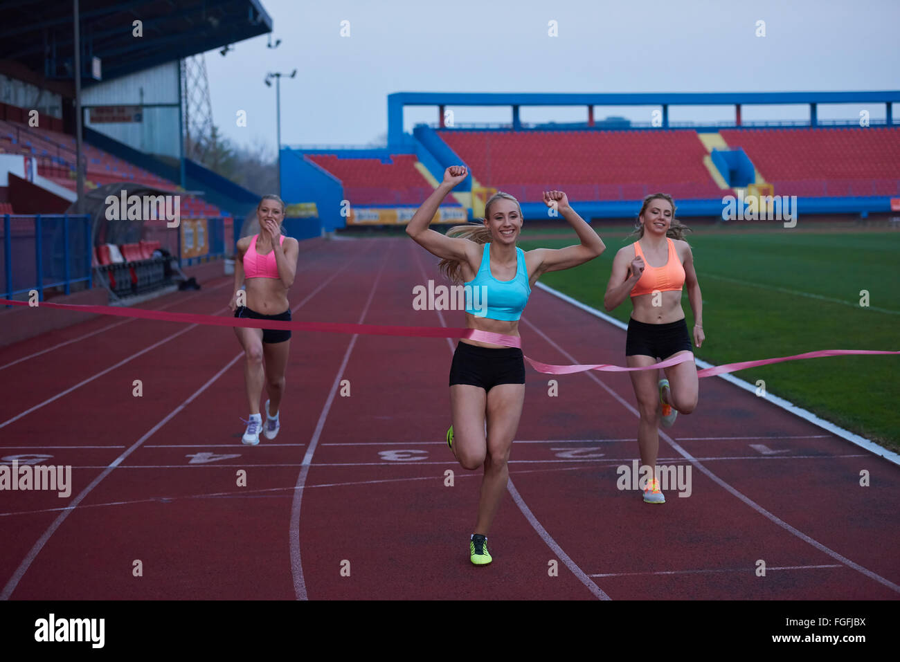 Female Runners Finishing Race Together Stock Photo - Alamy