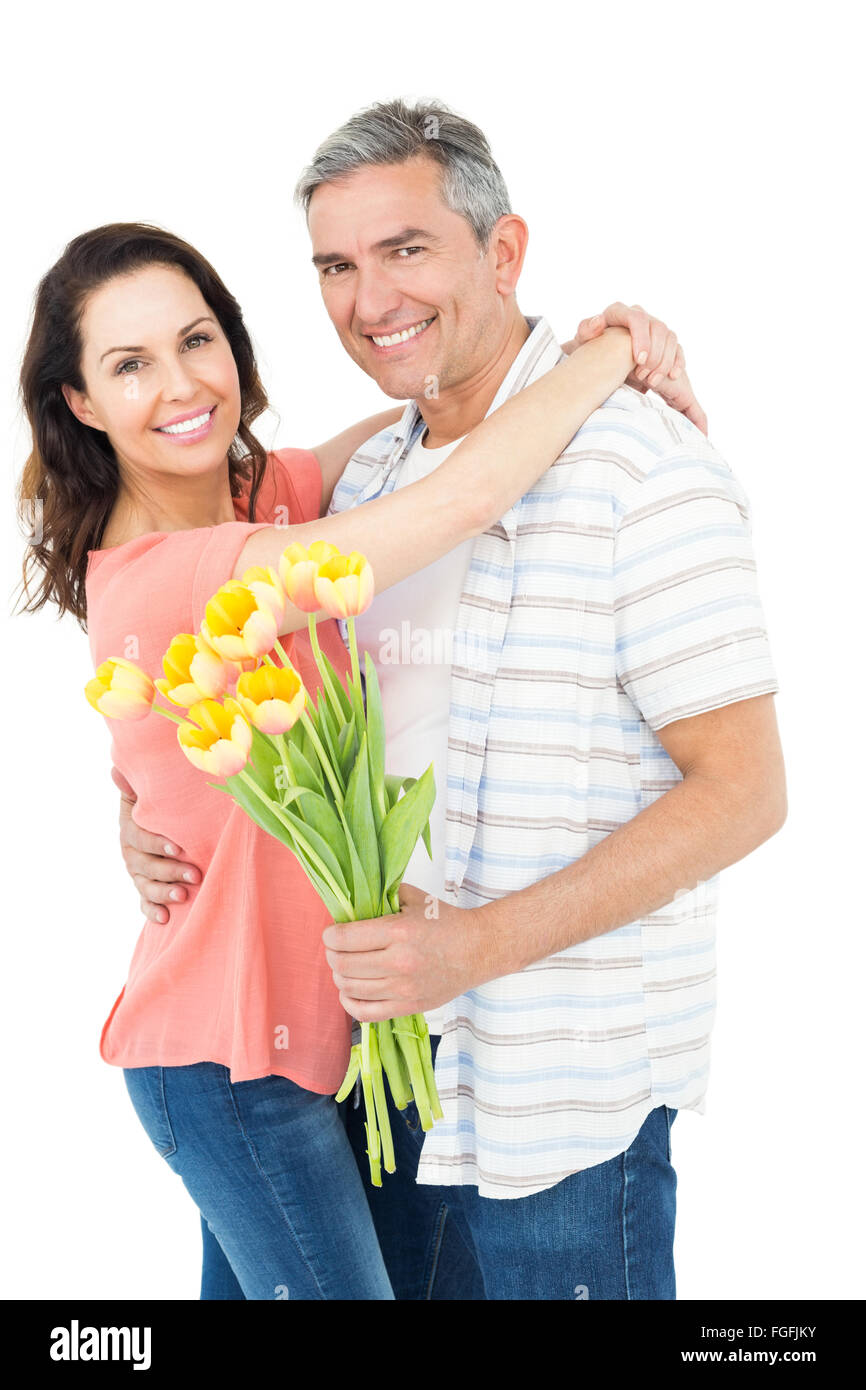 Smiling couple with flowers bouquet Stock Photo - Alamy