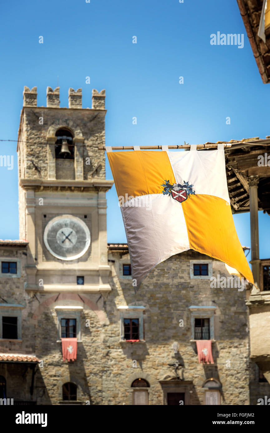 White and yellow flag and Palazzo Comunale historic building in Cortona ...