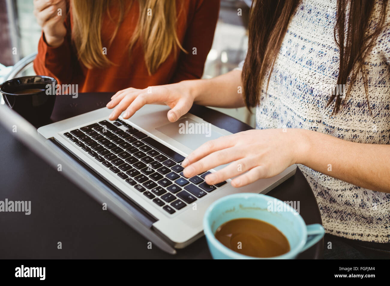 Friends using laptop together Stock Photo - Alamy