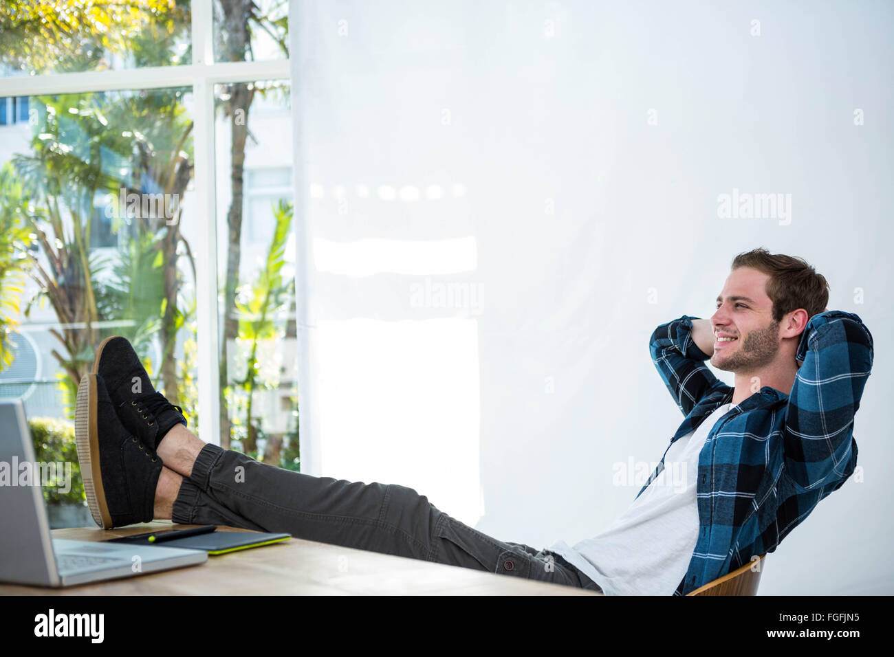 Handsome man relaxing on his desk chair Stock Photo - Alamy