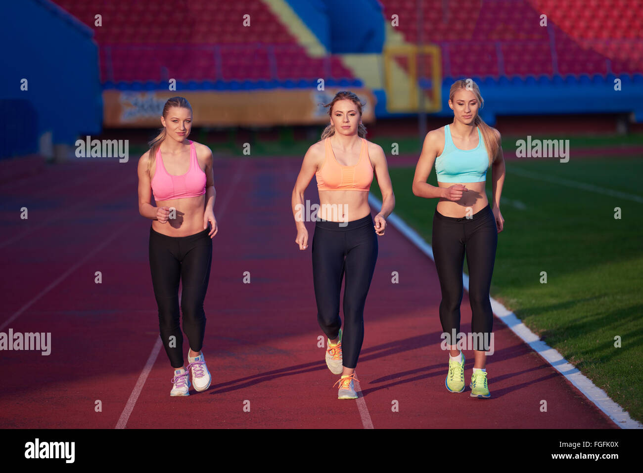 athlete woman group running on athletics race track Stock Photo - Alamy