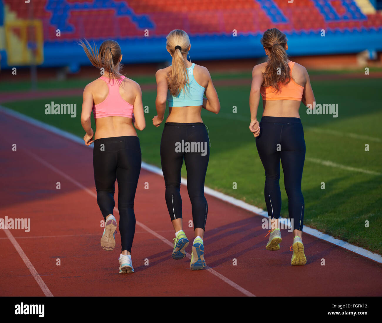 athlete woman group running on athletics race track Stock Photo - Alamy