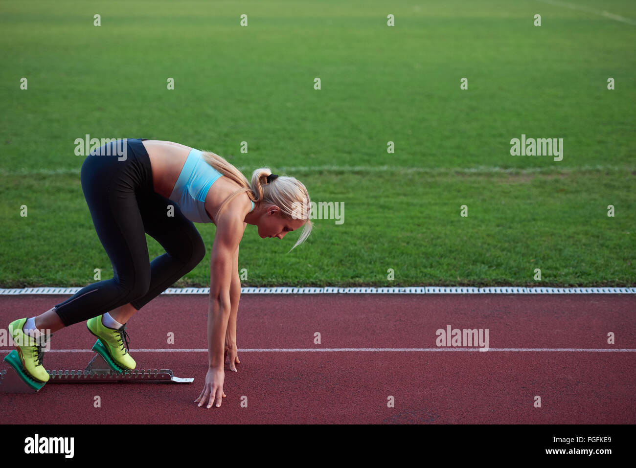 woman sprinter leaving starting blocks Stock Photo - Alamy