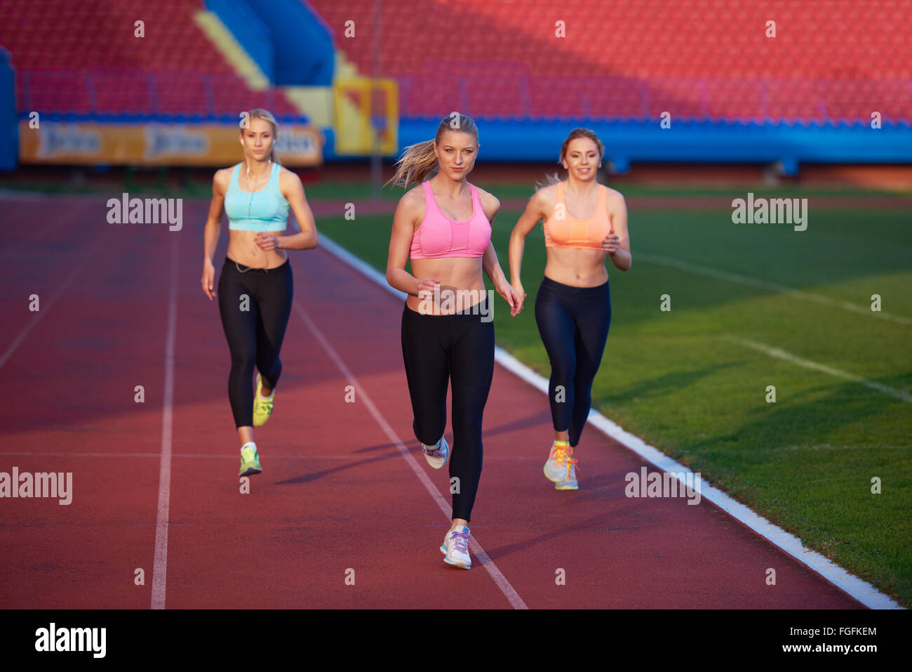 athlete woman group running on athletics race track Stock Photo - Alamy