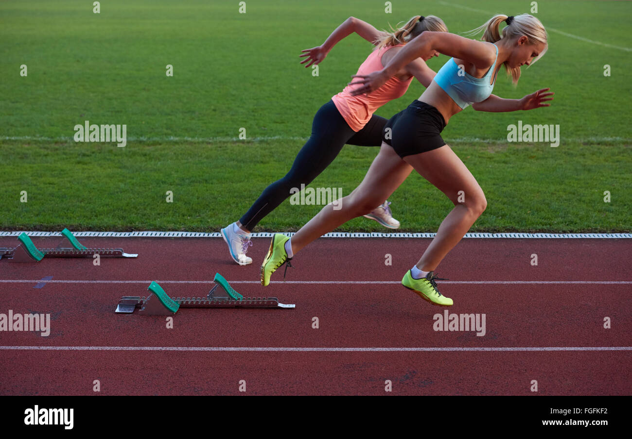 woman sprinter leaving starting blocks Stock Photo - Alamy
