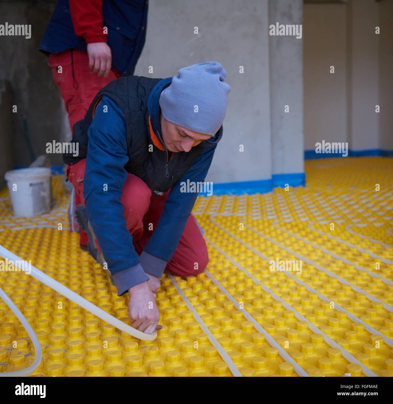Workers installing underfloor heating hi-res stock photography and ...