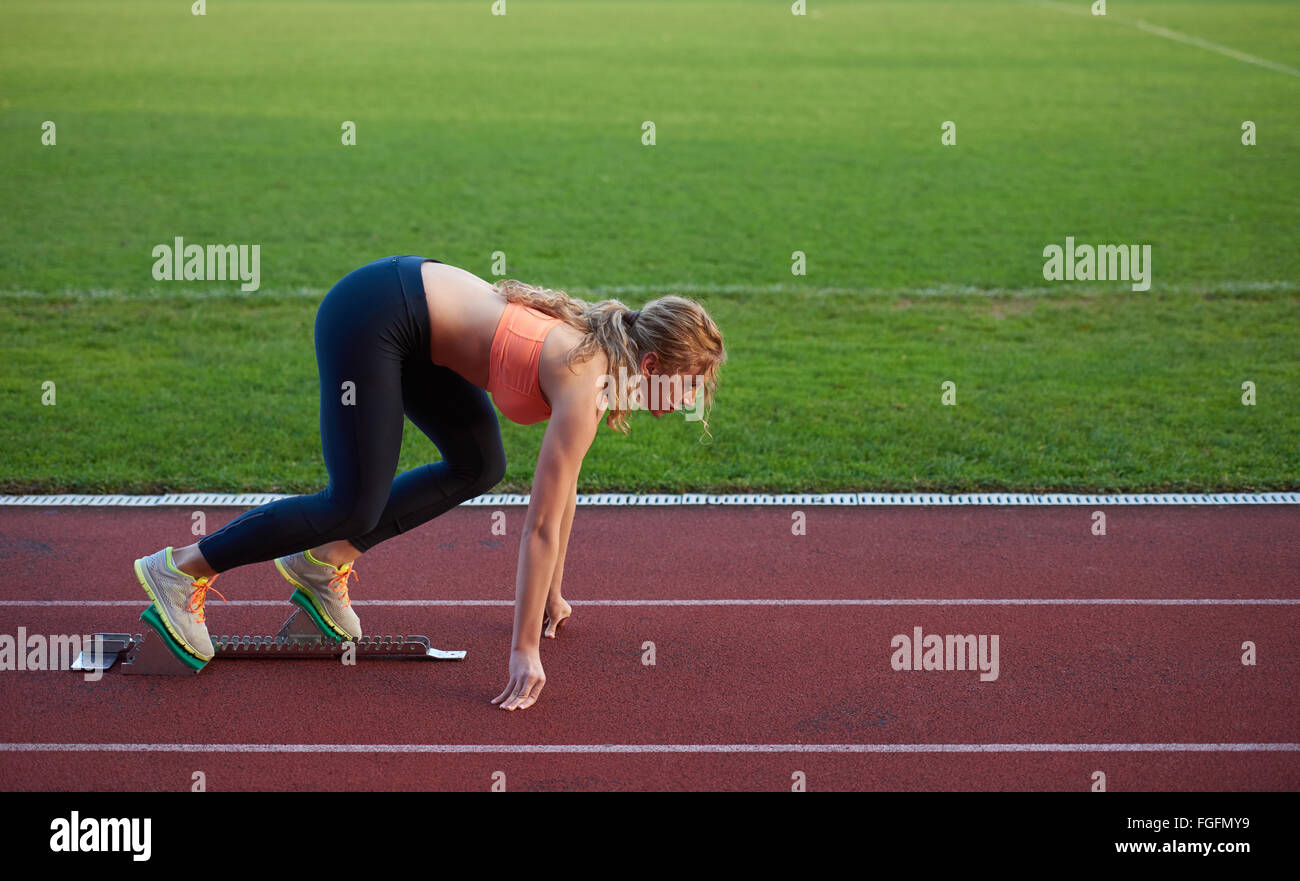 woman sprinter leaving starting blocks Stock Photo - Alamy