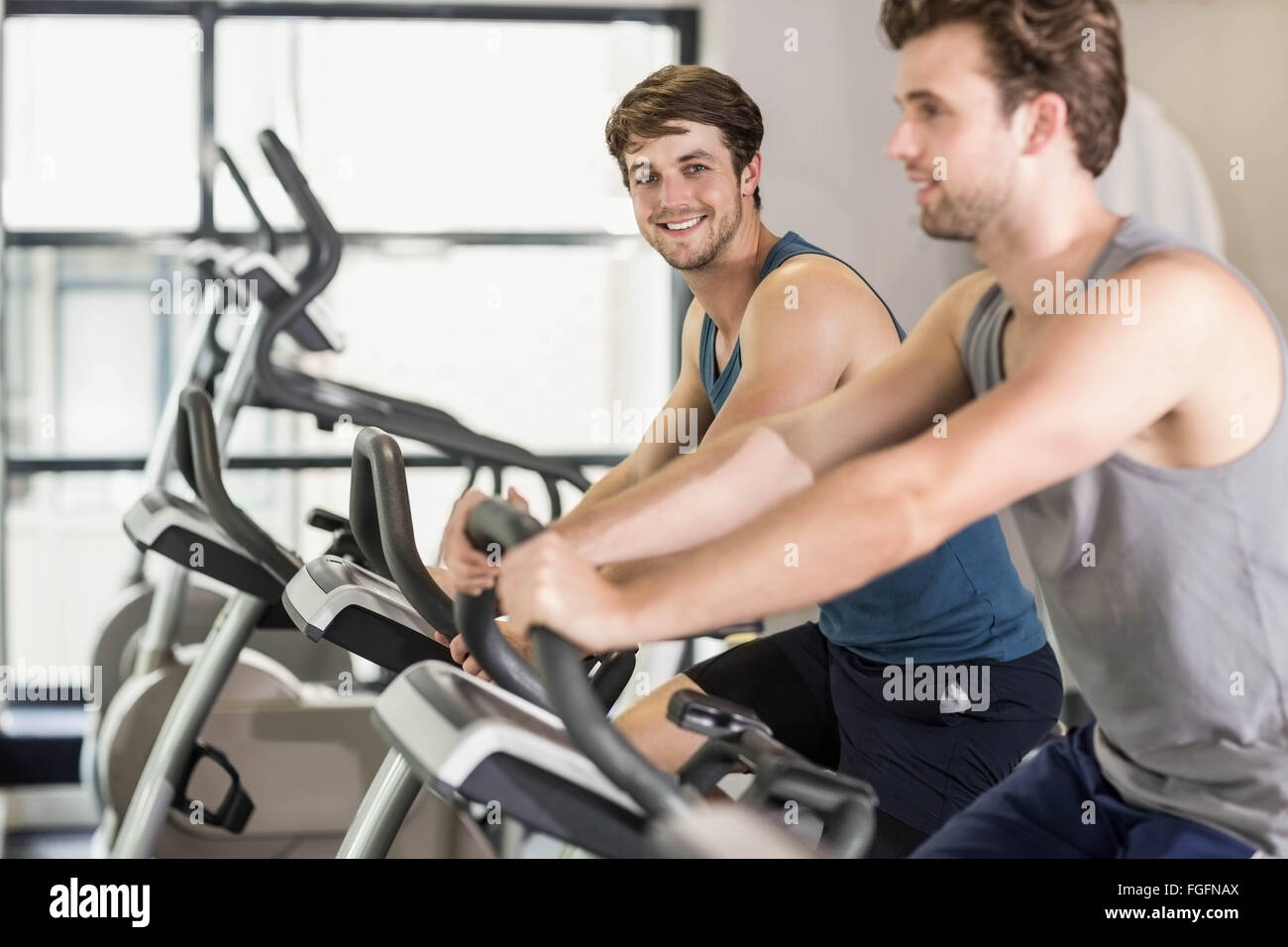 Fit people doing exercise bike Stock Photo - Alamy