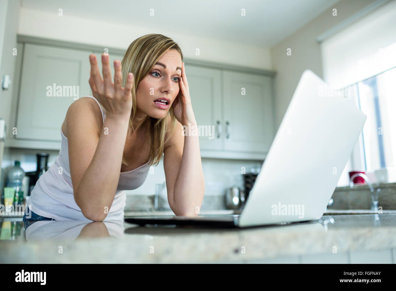 Woman looking perplexed at laptop hi-res stock photography and images ...
