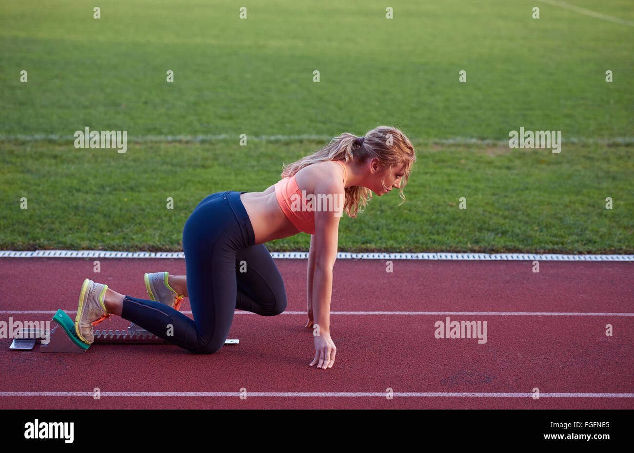 woman sprinter leaving starting blocks Stock Photo - Alamy