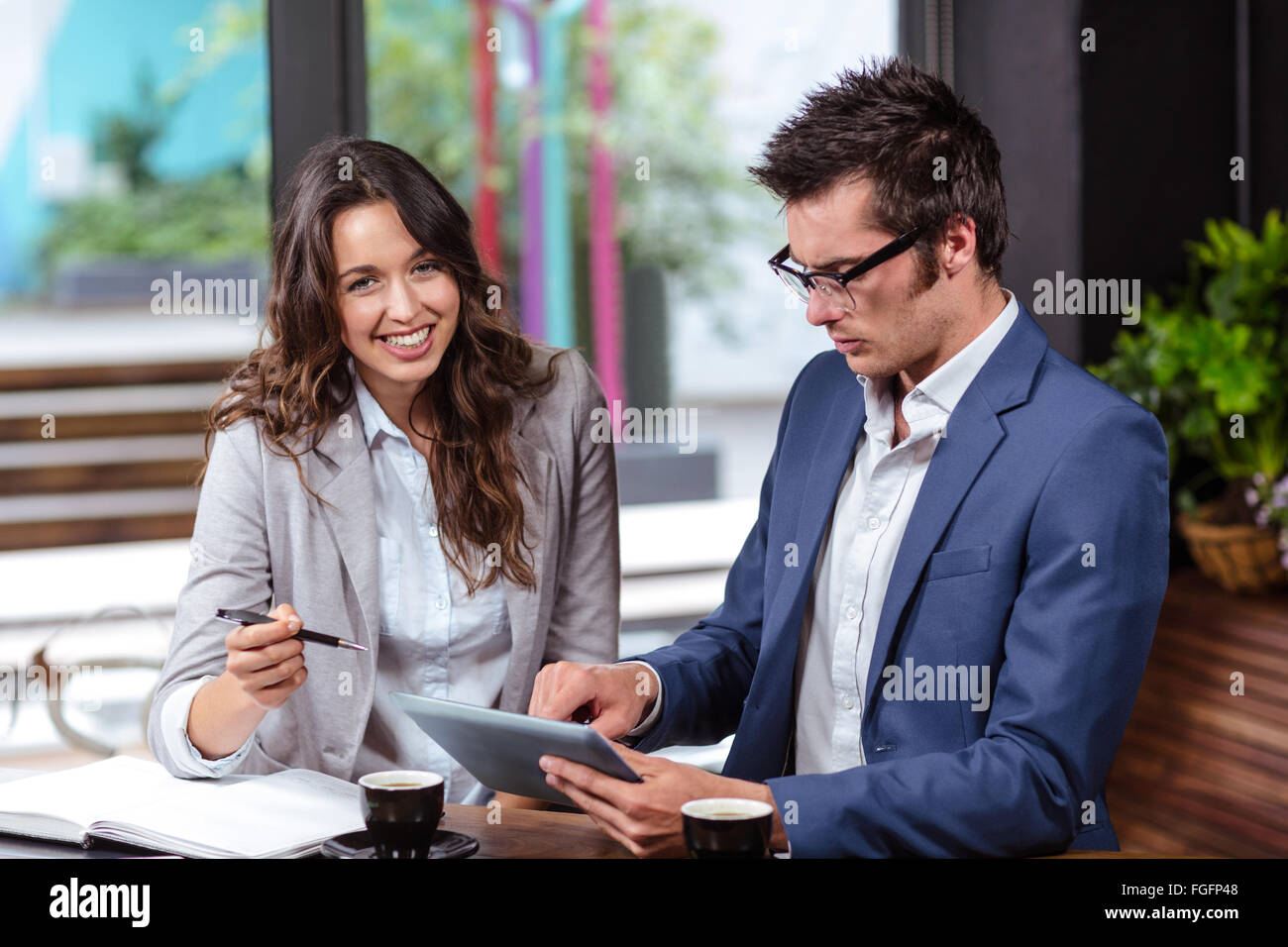 People using tablet and notebook Stock Photo - Alamy