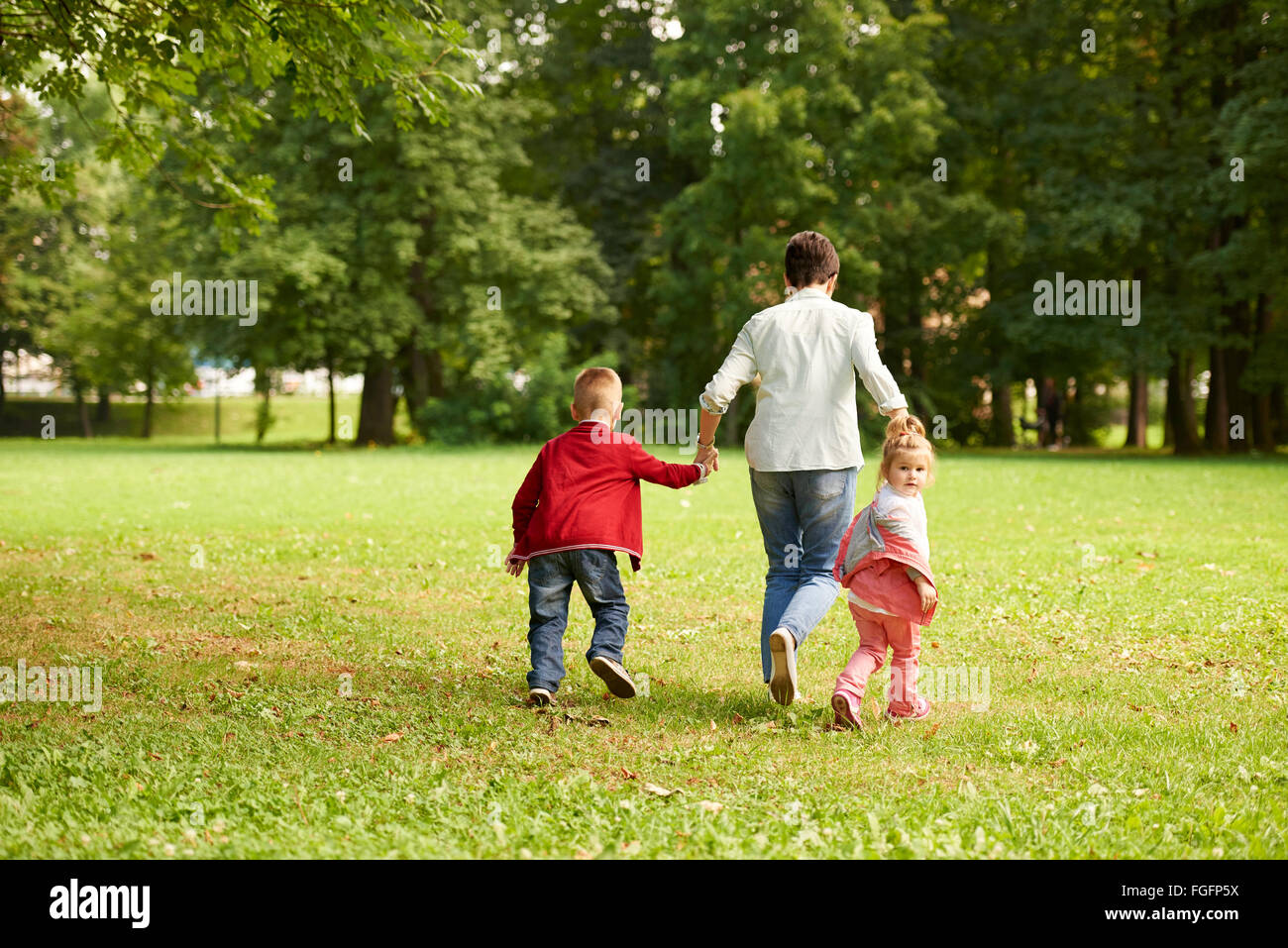 happy family playing together outdoor in park Stock Photo - Alamy