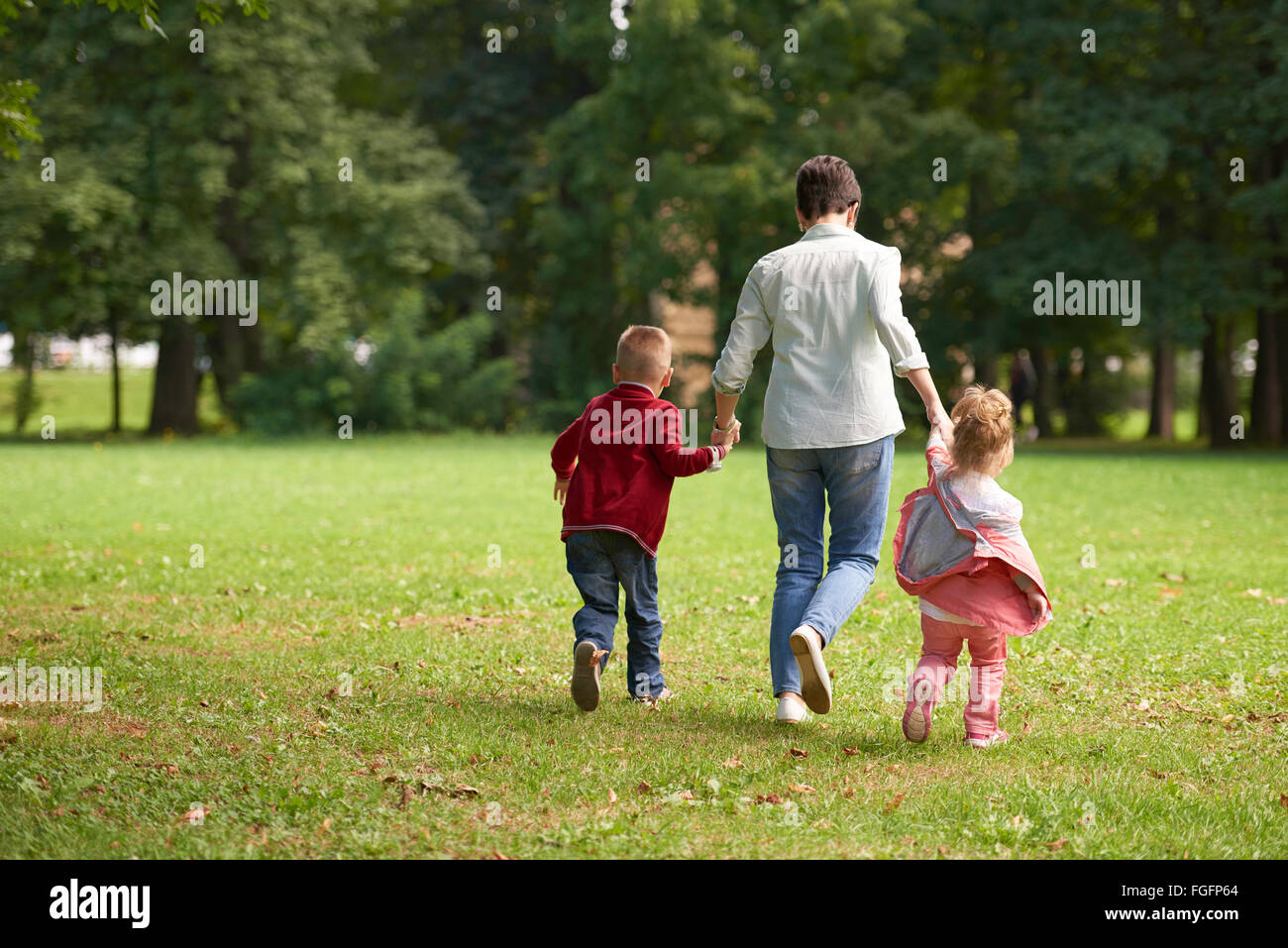 happy family playing together outdoor in park Stock Photo - Alamy