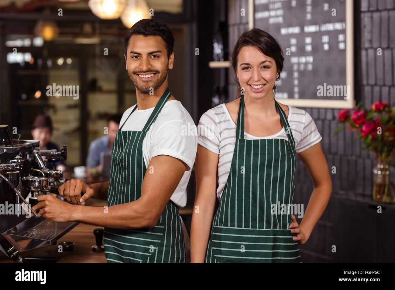 Smiling baristas working Stock Photo - Alamy