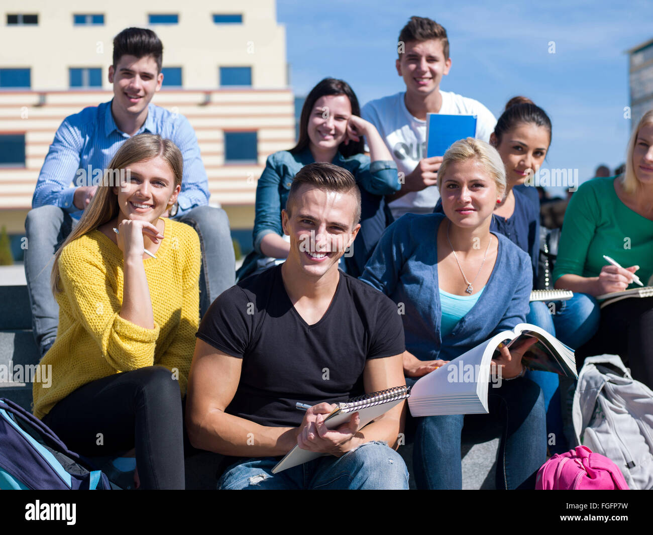 students outside sitting on steps Stock Photo - Alamy