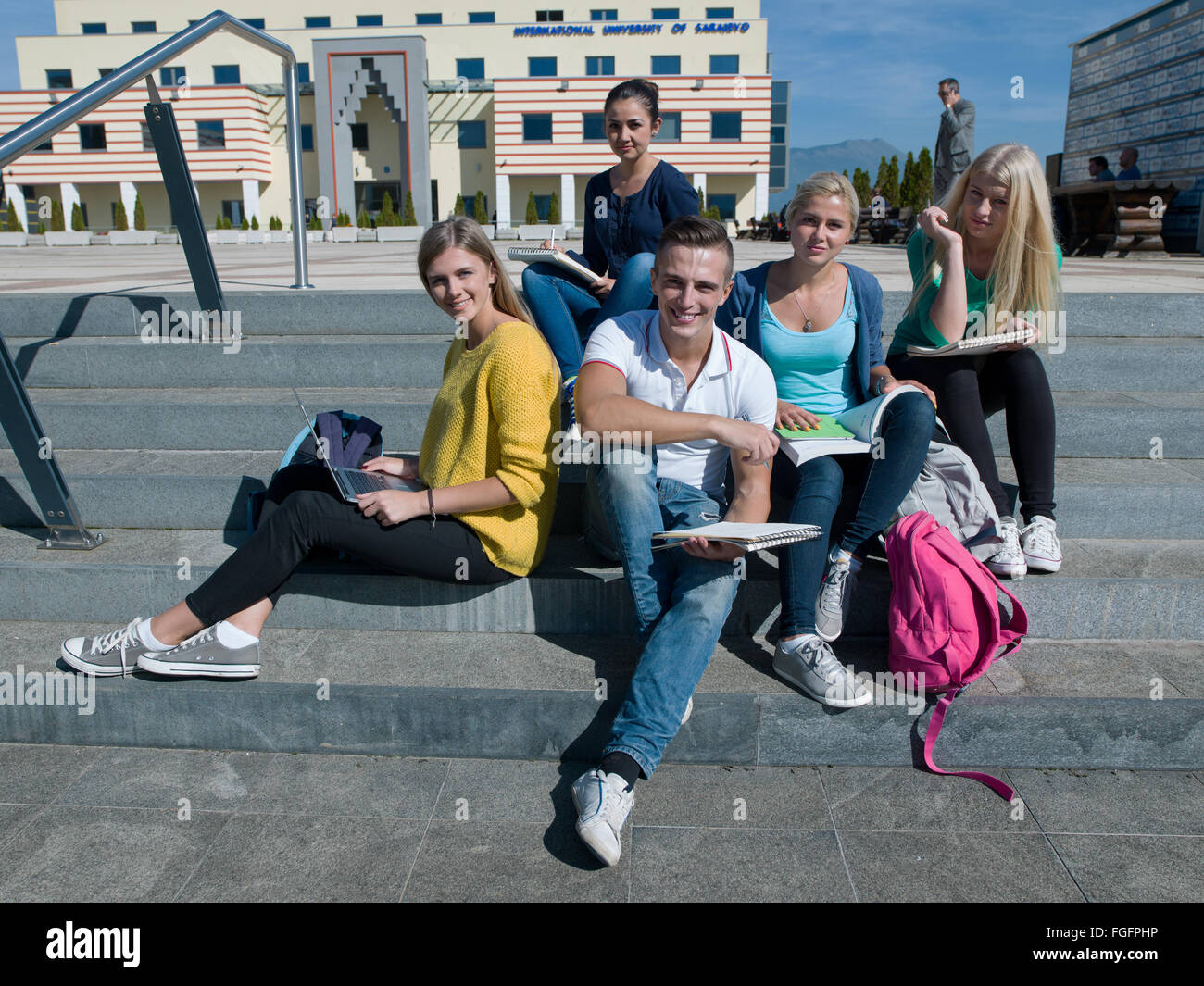 students outside sitting on steps Stock Photo - Alamy