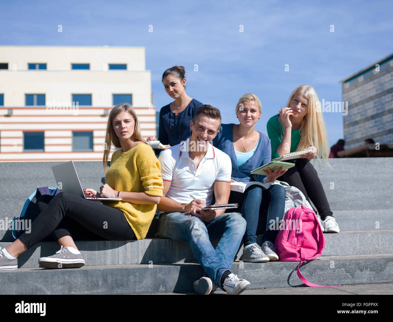 students outside sitting on steps Stock Photo - Alamy