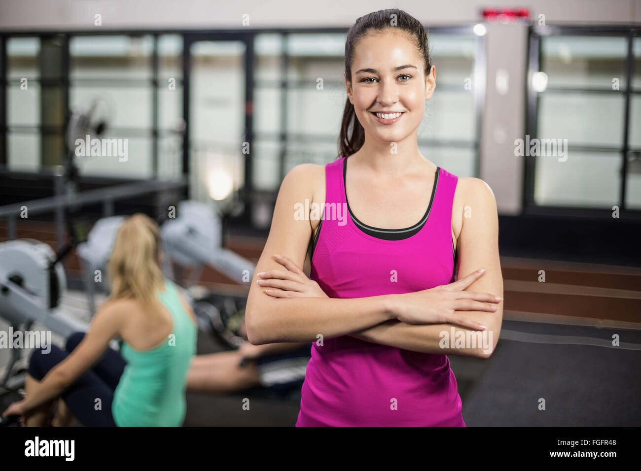 Sportswoman with crossed arms Stock Photo - Alamy