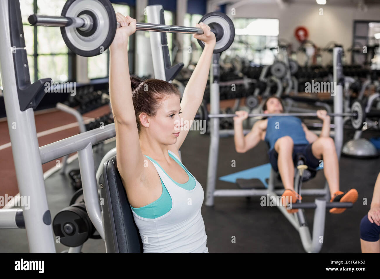 Fit woman lifting barbell Stock Photo - Alamy