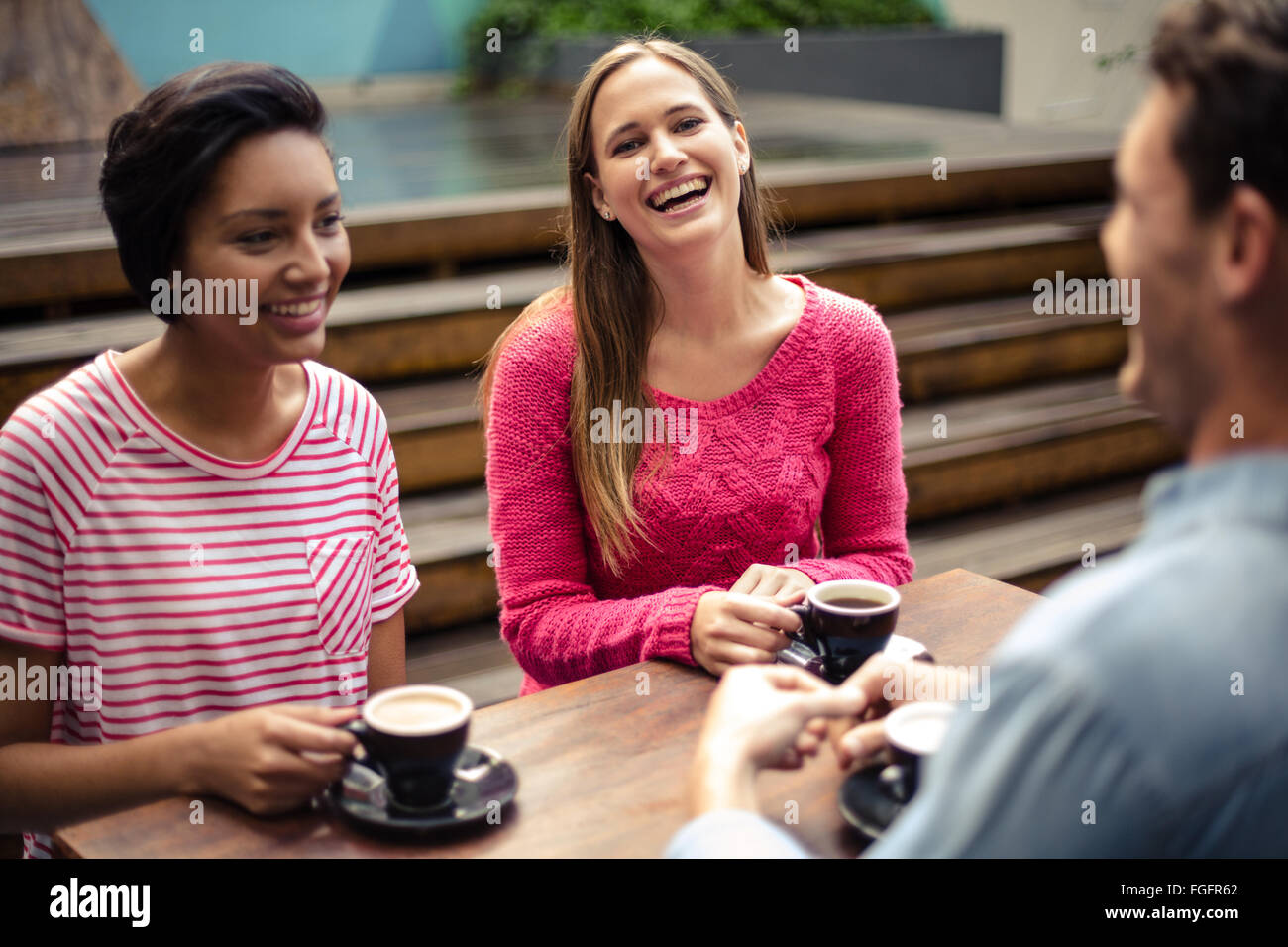 Happy friends having coffee together Stock Photo - Alamy