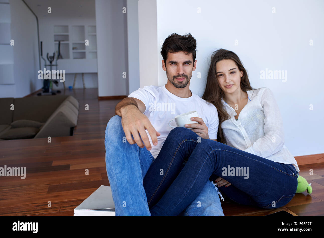 relaxed young couple at home staircase Stock Photo - Alamy