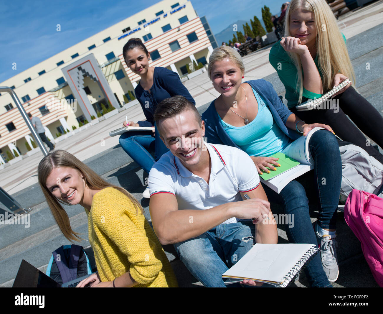 students outside sitting on steps Stock Photo - Alamy