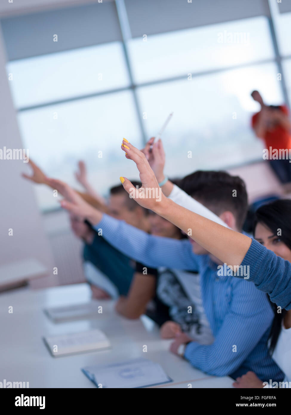 students group raise hands up Stock Photo - Alamy