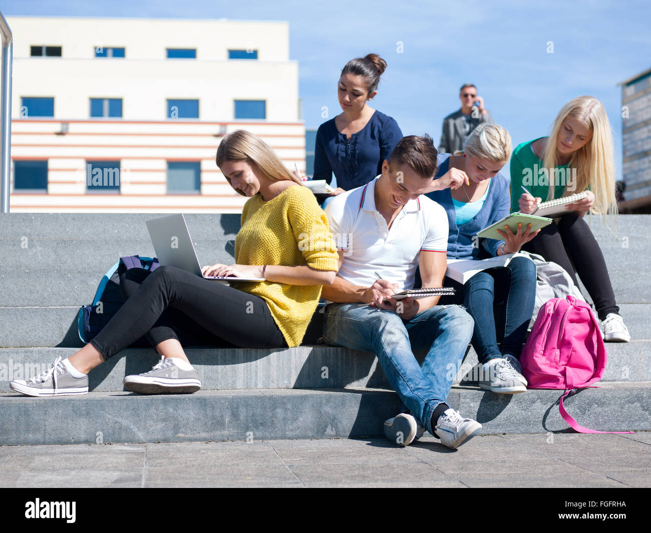 students outside sitting on steps Stock Photo - Alamy
