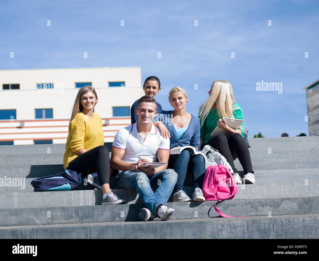 students outside sitting on steps Stock Photo - Alamy