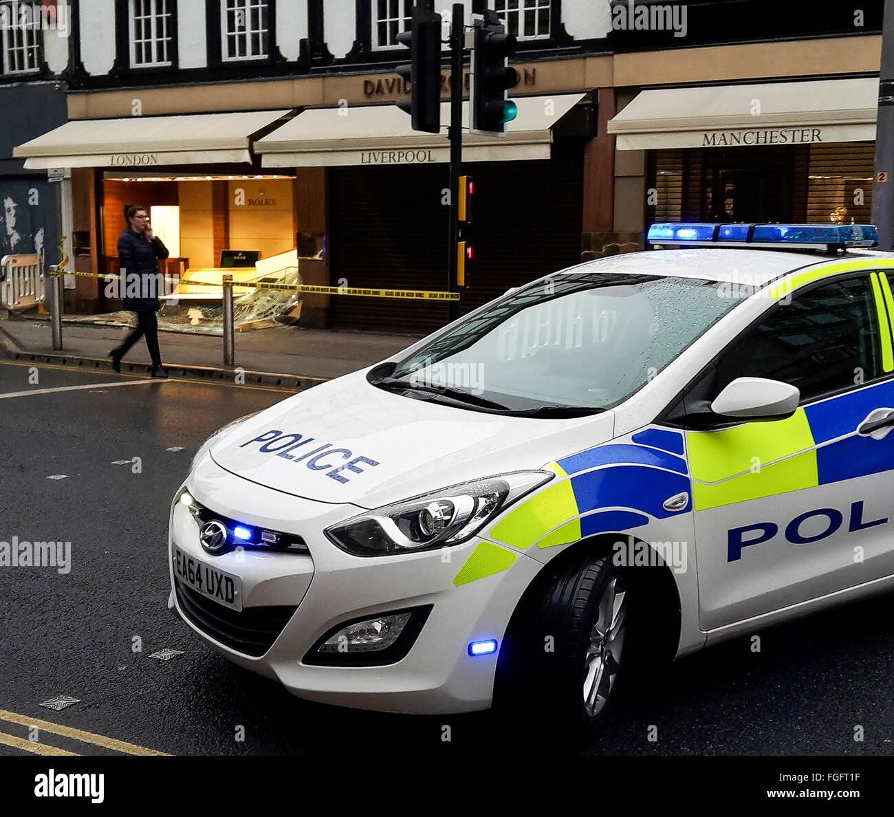 Police car with blue flashing lights in foreground, Jewelers with ...