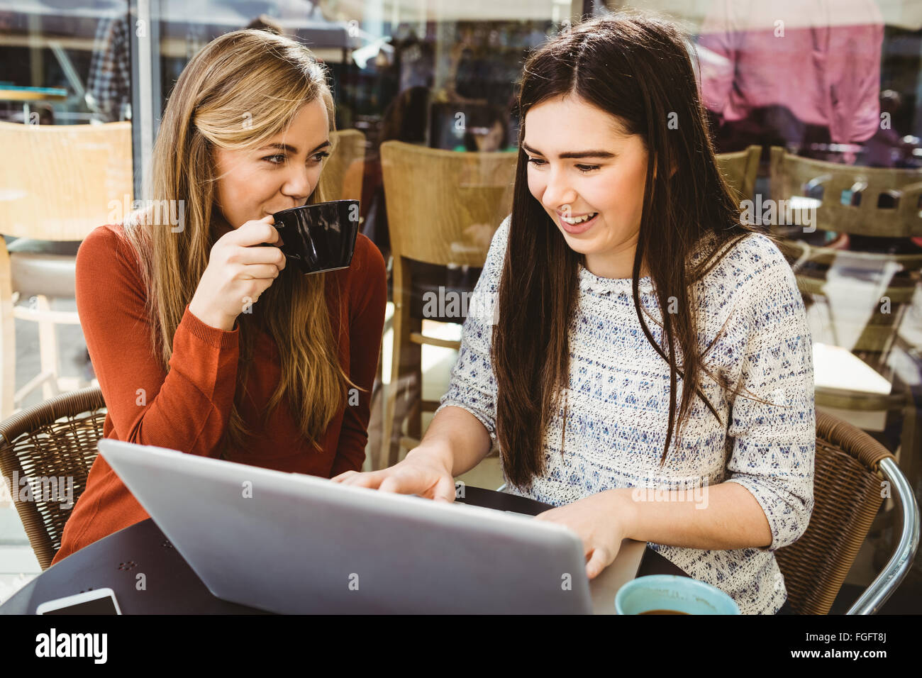 Friends using laptop together Stock Photo - Alamy
