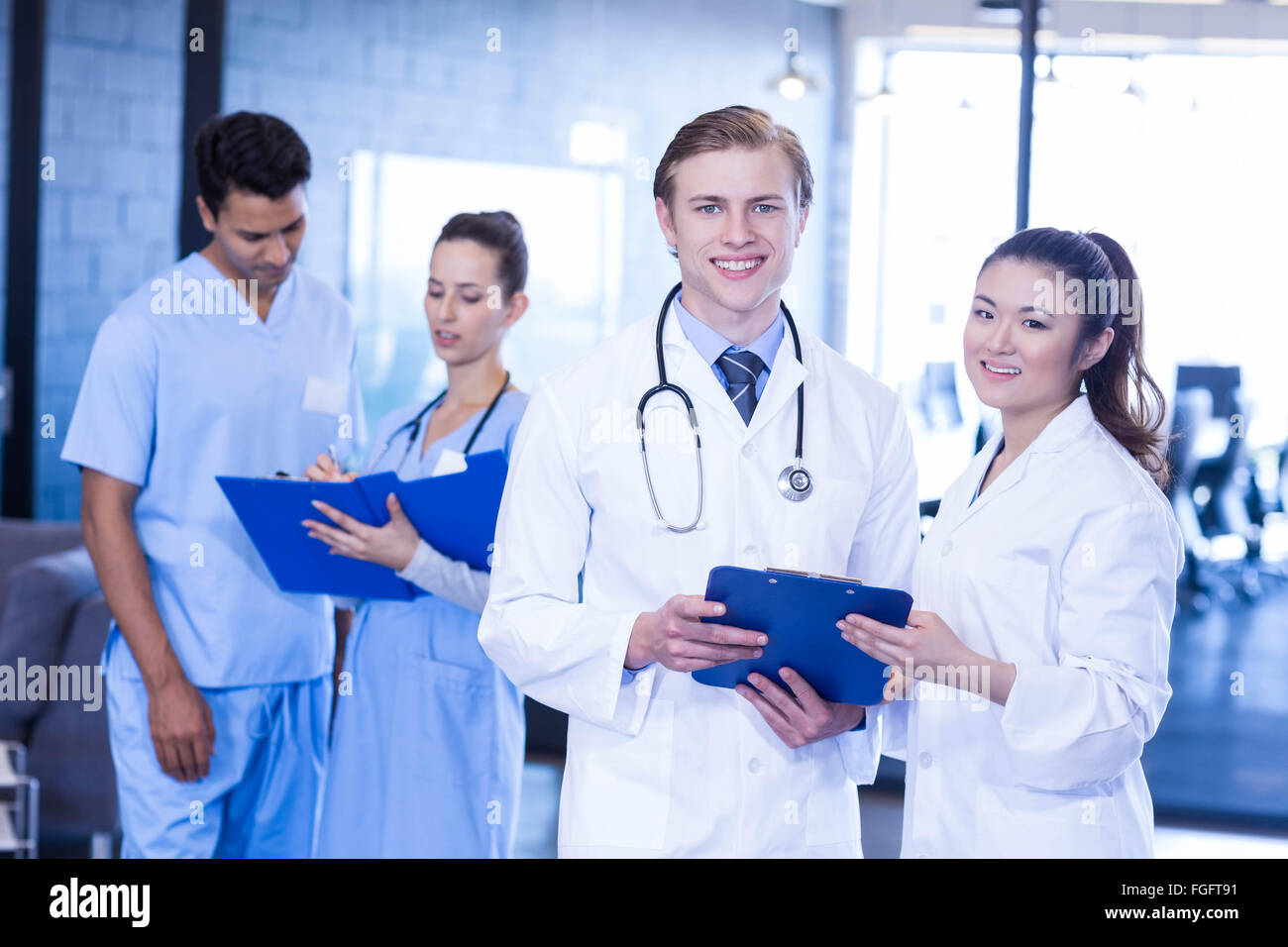 Doctors looking at medical report Stock Photo - Alamy