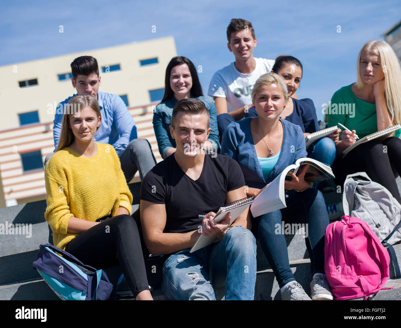 students outside sitting on steps Stock Photo - Alamy