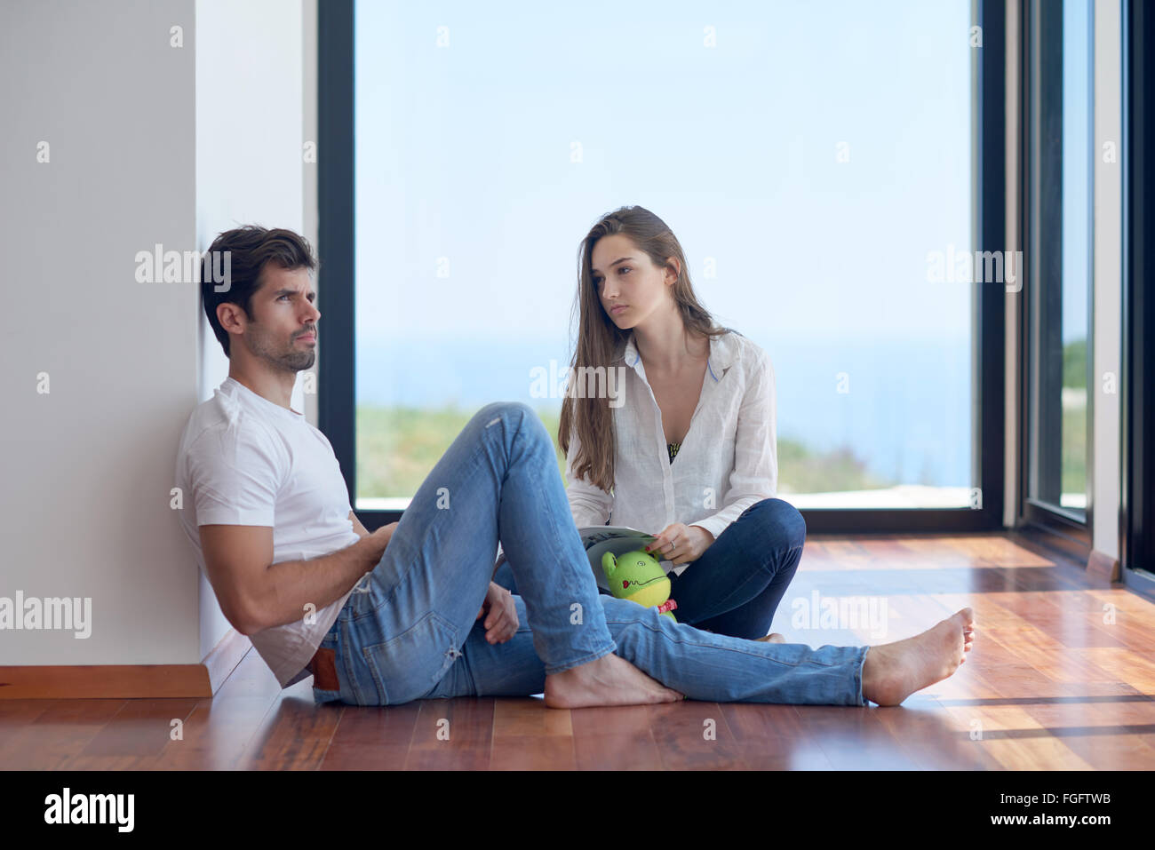 relaxed young couple at home staircase Stock Photo - Alamy
