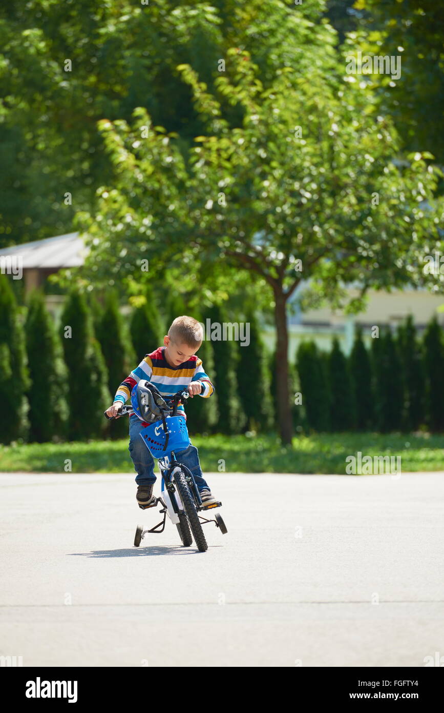 happy boy learning to ride his first bike Stock Photo - Alamy